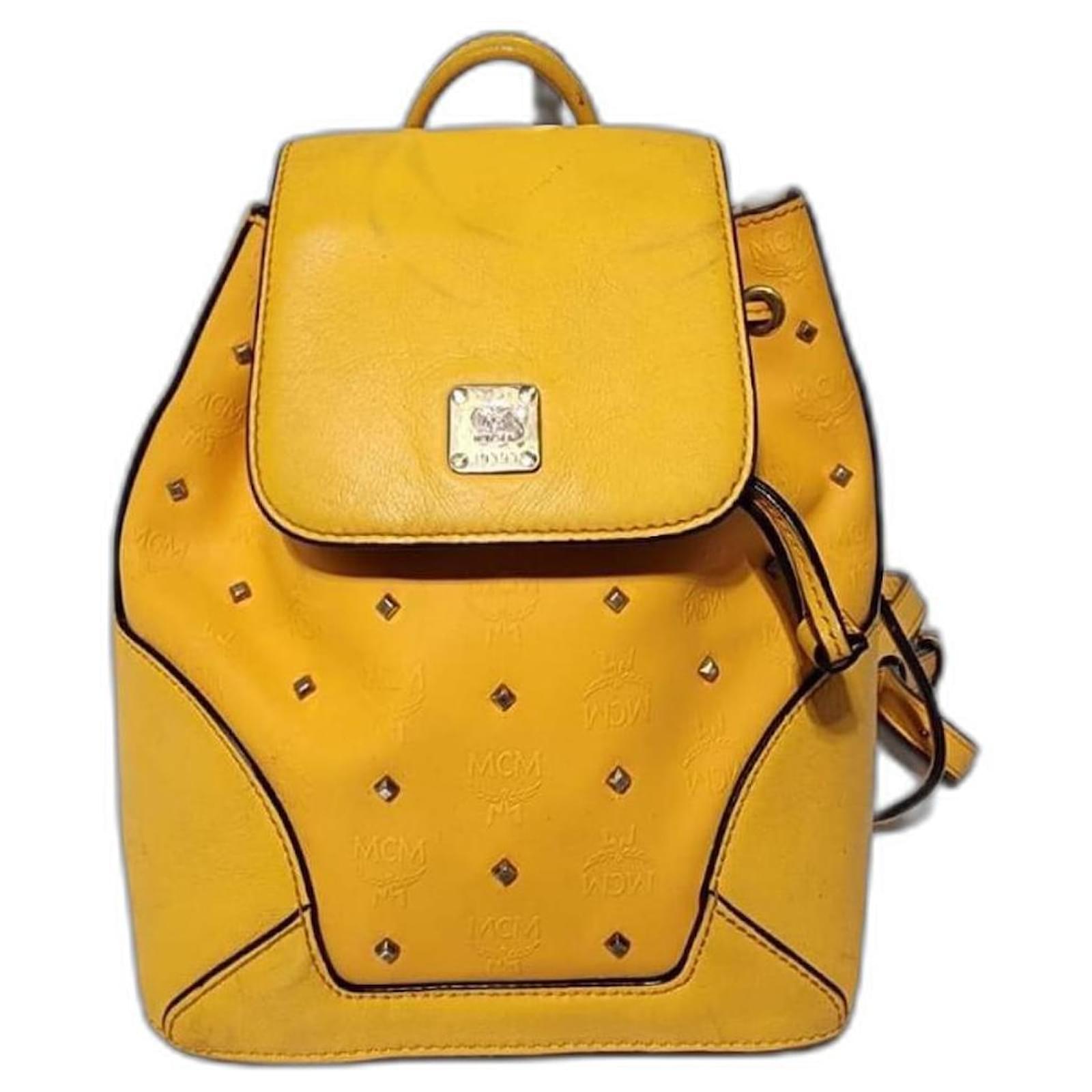 MCM Coated Canvas Monogram Studded Mini Claudia Backpack Yellow Leather ...