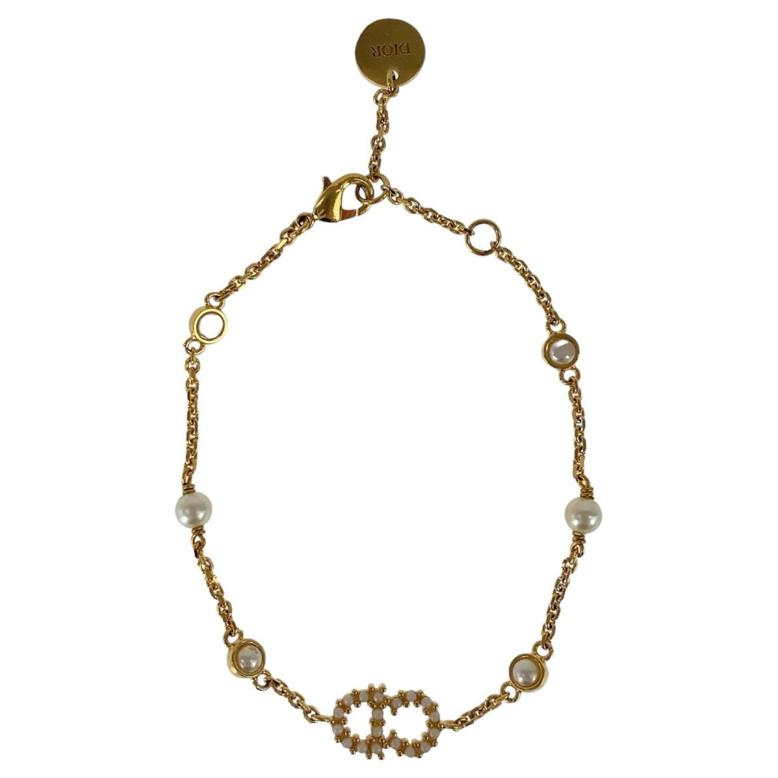 Christian Dior Dior Gold Metal CD Logo Faux Pearl Bracelet Golden Metallic Plastic ref.1736048 Joli Closet
